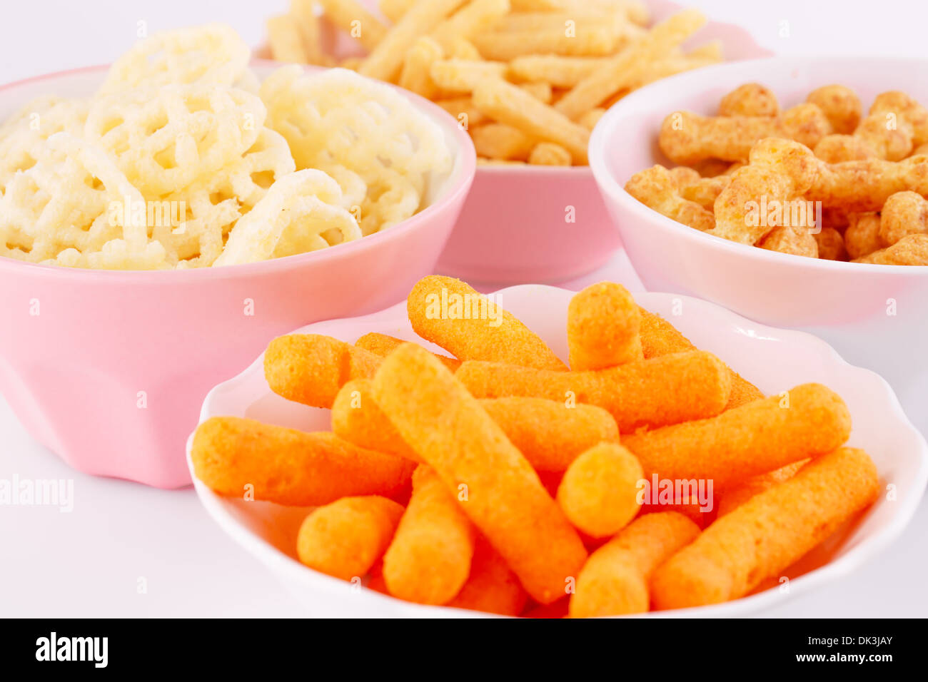 Potato, corn and wheat chips in bowls isolated on gray background Stock ...