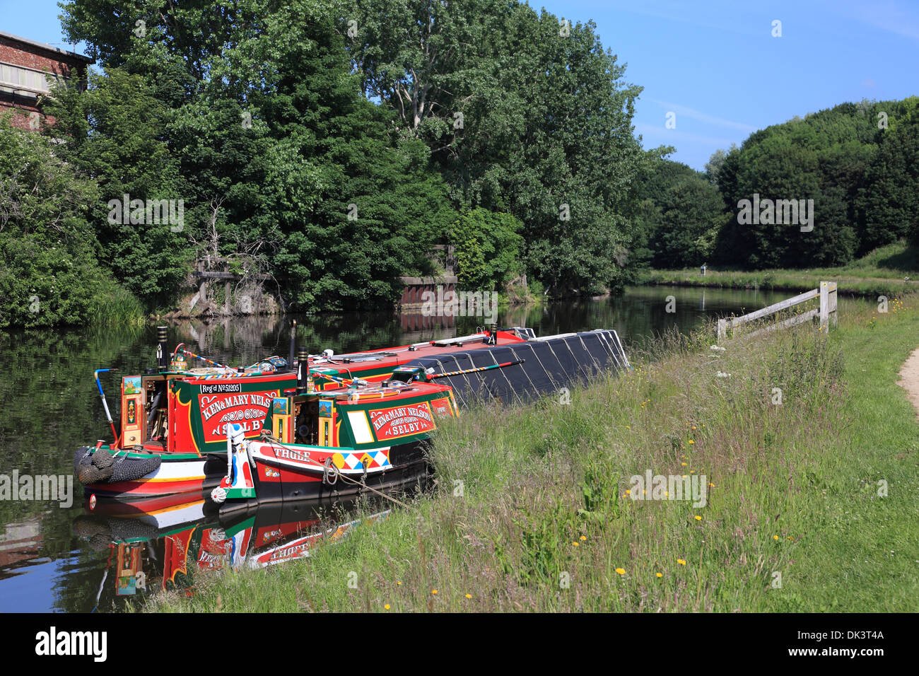 Narrowboat and butty on the river Weaver next to Tata Chemicals Europe ...