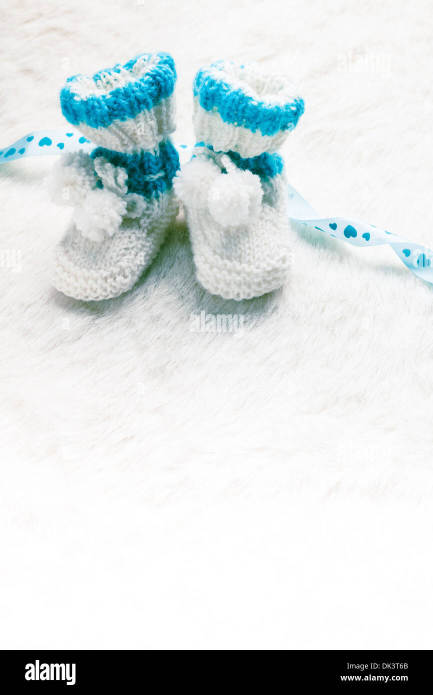 Knitted blue baby booties for little boy Stock Photo - Alamy
