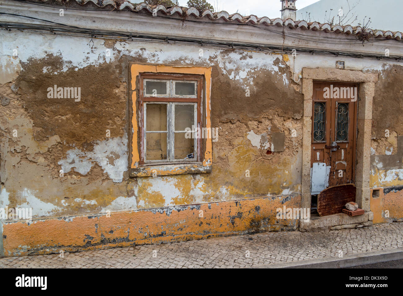 Old building in a state of dilapidation with paint and cement peeling ...