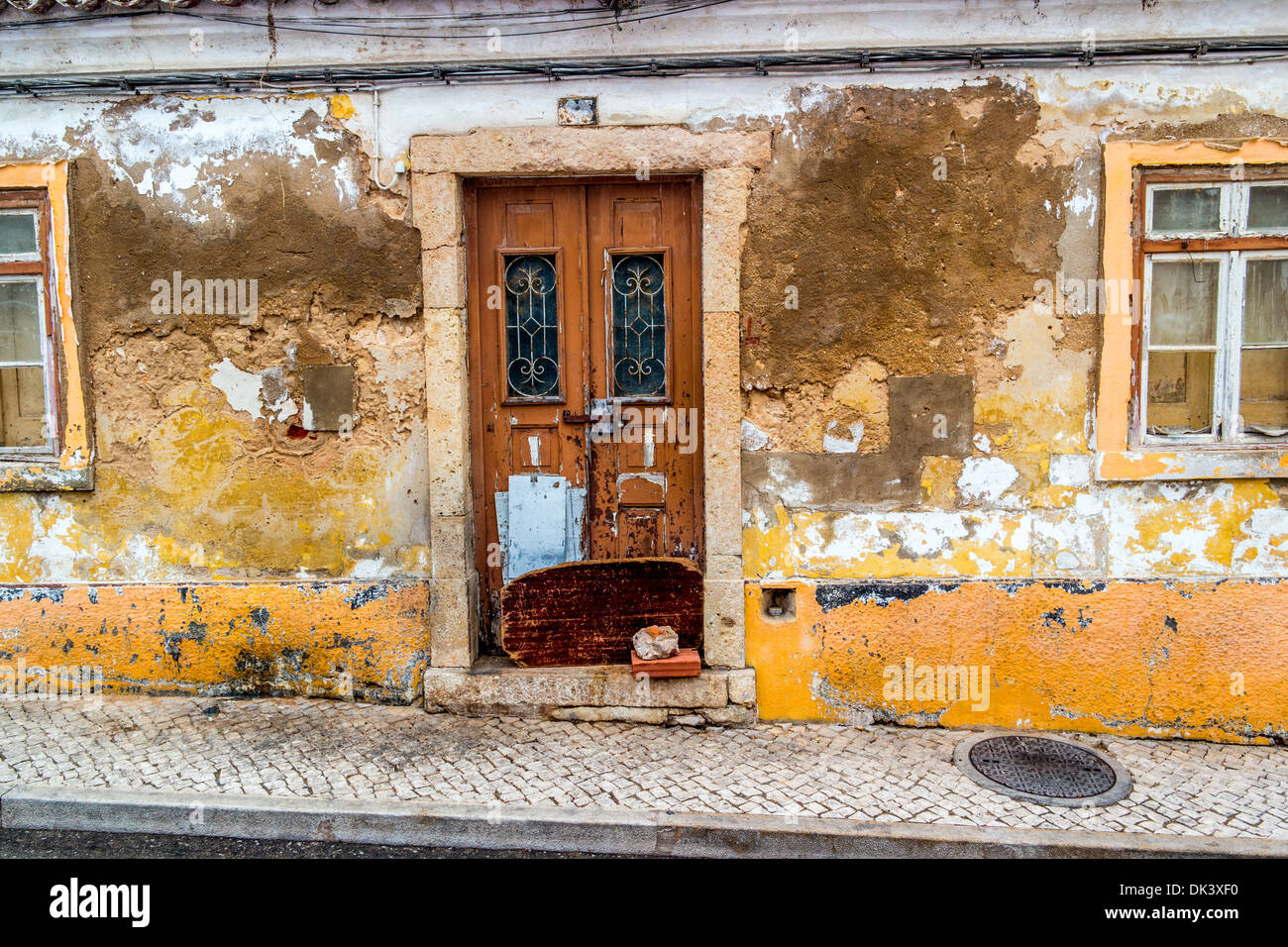 Old building in a state of dilapidation with paint and cement peeling ...