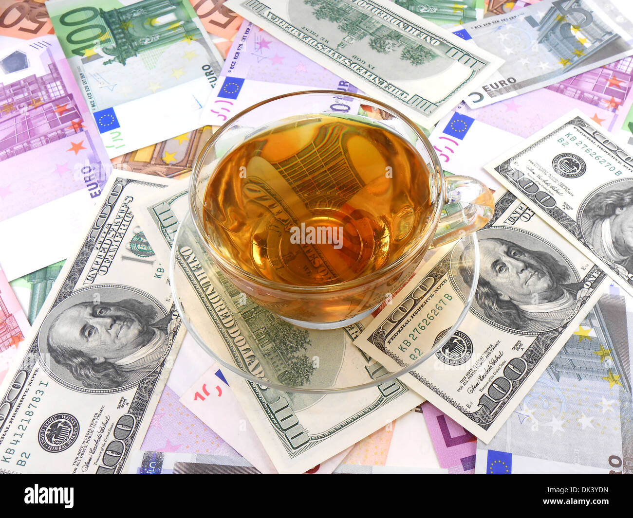 tea or coffee cup on money wallpaper Stock Photo - Alamy