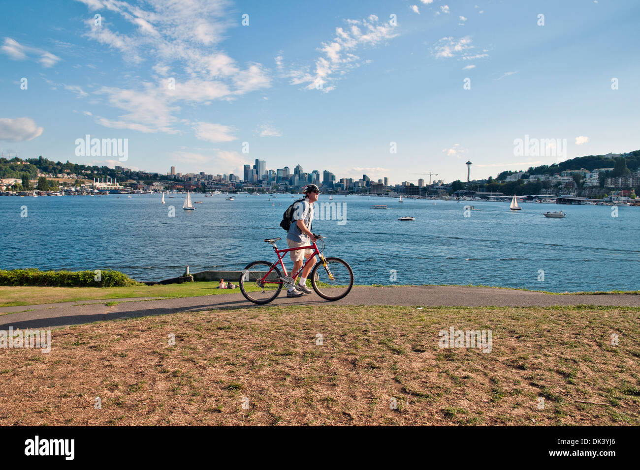 Cyclist with bike along the lake, Seattle, state of Washington, USA ...