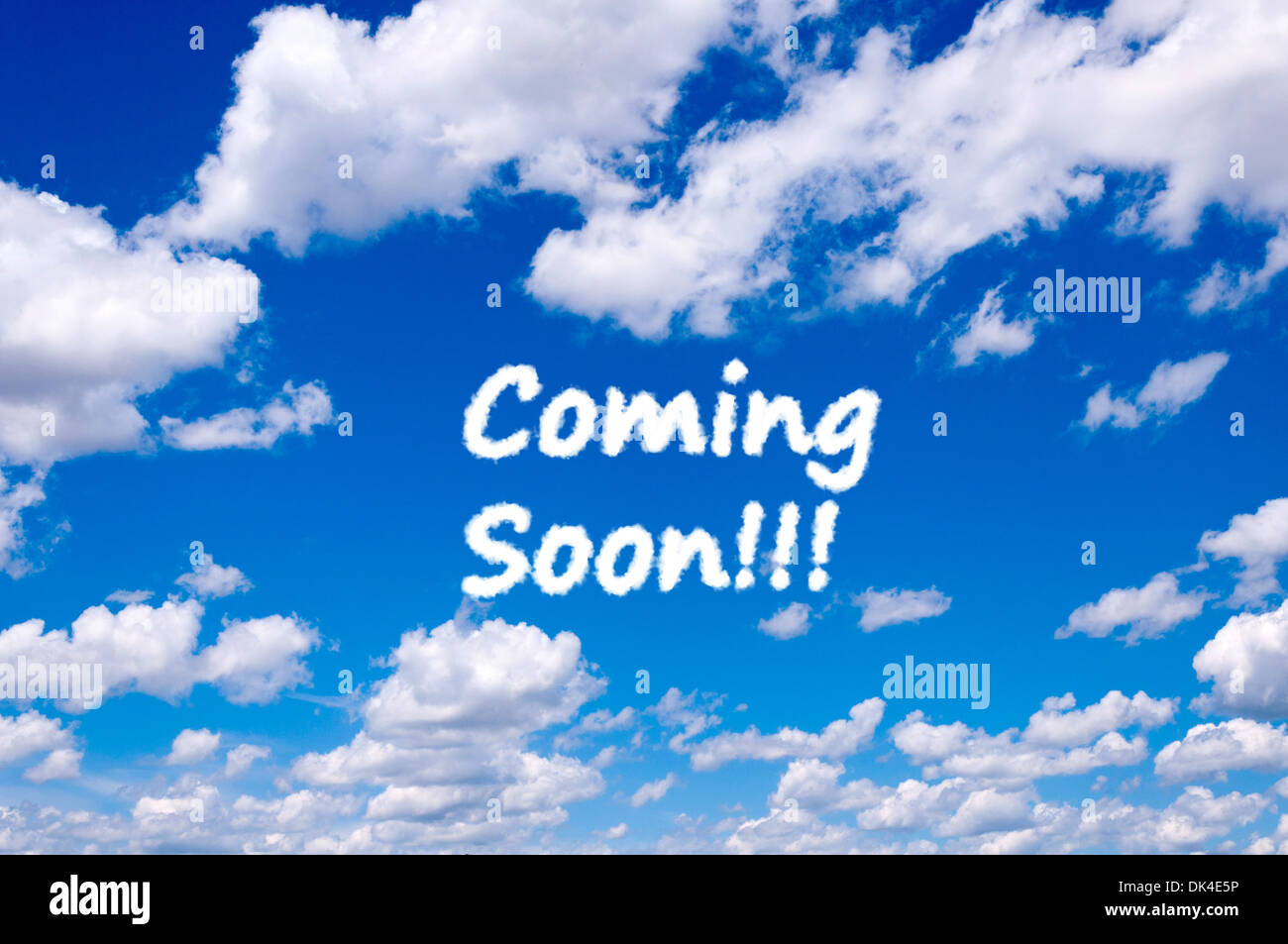 Coming soon sign clouds on the clear blue sky Stock Photo - Alamy