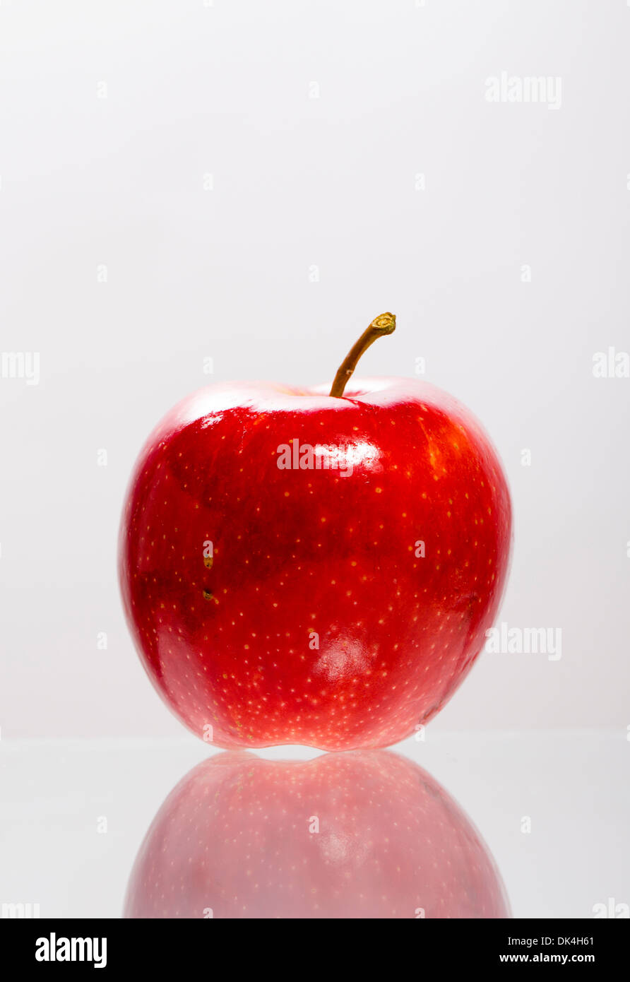 Single red apple on glass surface Stock Photo - Alamy