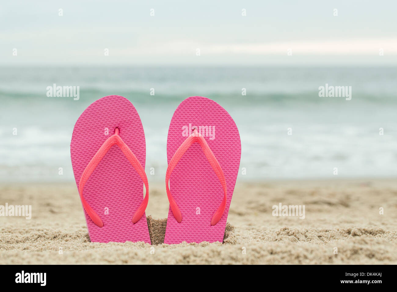 Pink sandals in the sand Stock Photo - Alamy