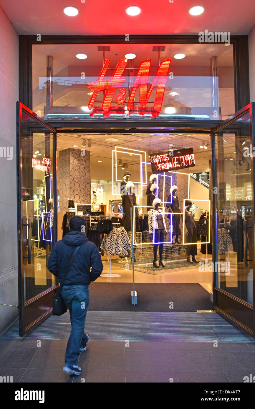 Back view customer entering H&M retail business clothing store with ...