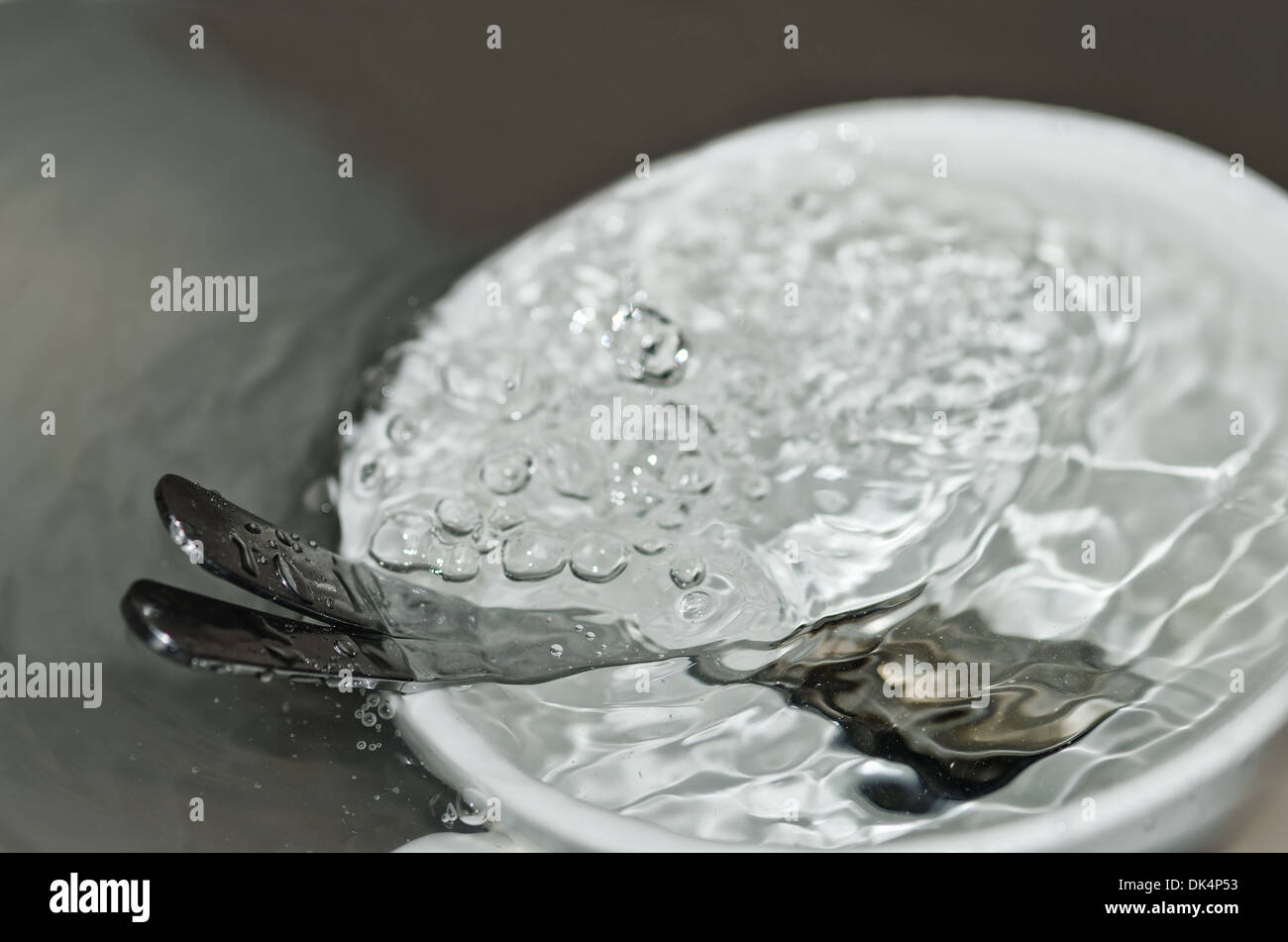 putting off the inevitable washing up cutlery soaking cups mugs in ...