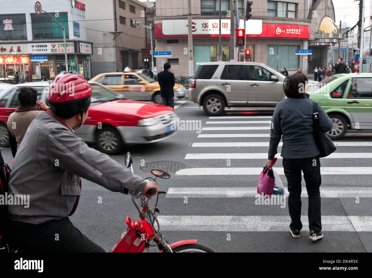 Pedestrian crossing on West Fuxing Road in Shanghai, China. In center ...