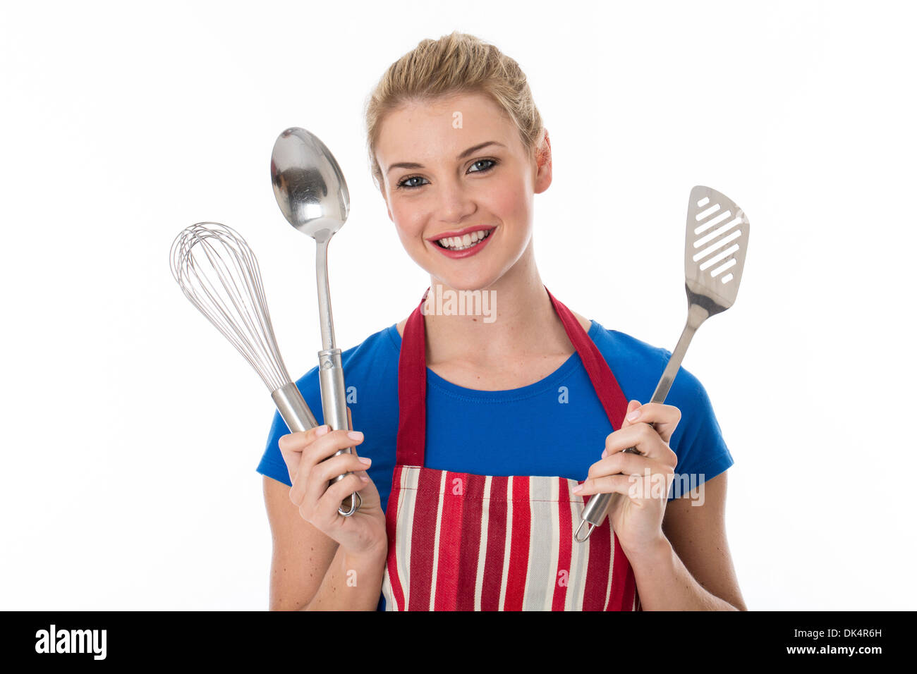 Model Released. Attractive Young Woman Holding Cooking Utensils Stock ...