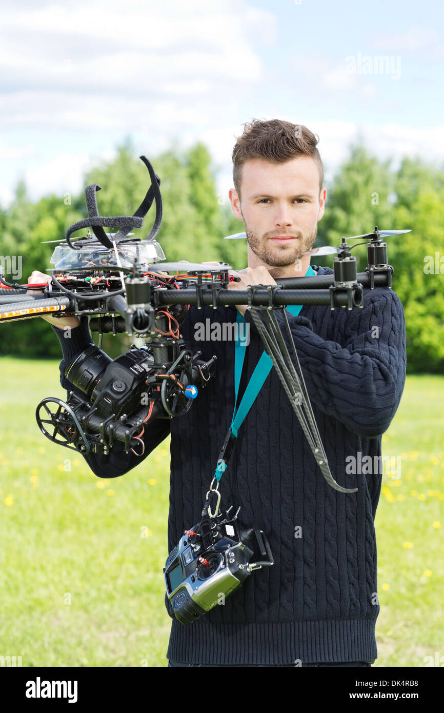 Male Engineer Holding UAV Helicopter in Park Stock Photo - Alamy
