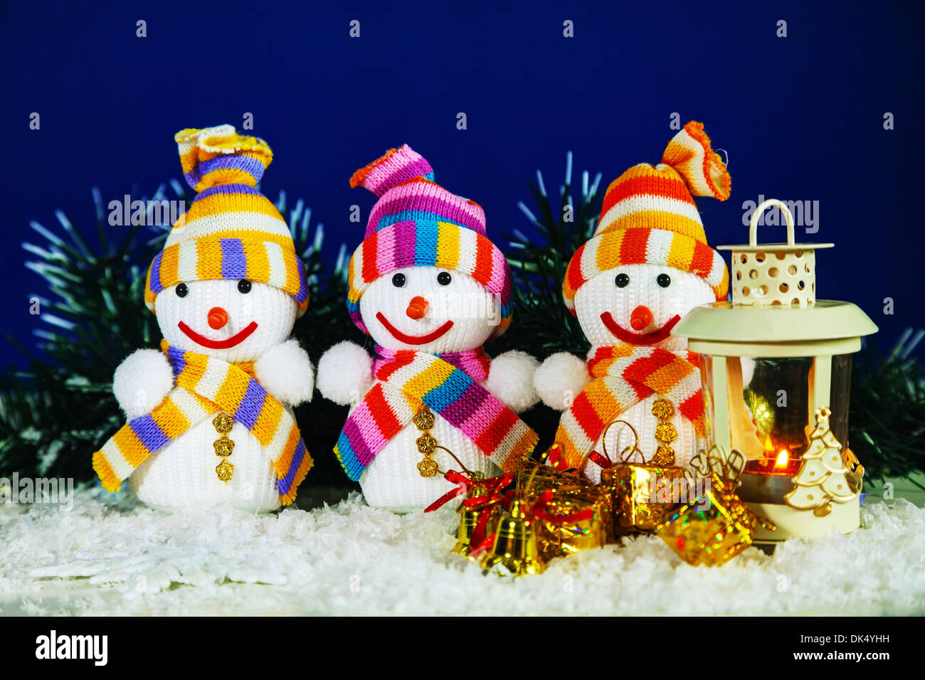 Three snowman with a lantern and presents Stock Photo - Alamy