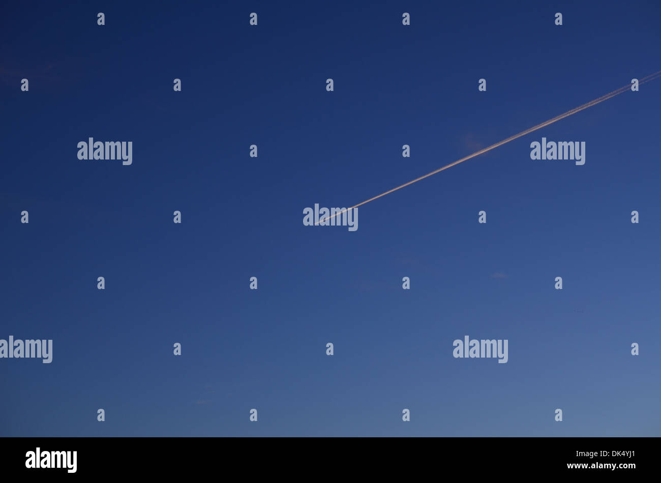 totally clear blue sky with a single plane half way in the sky Stock ...
