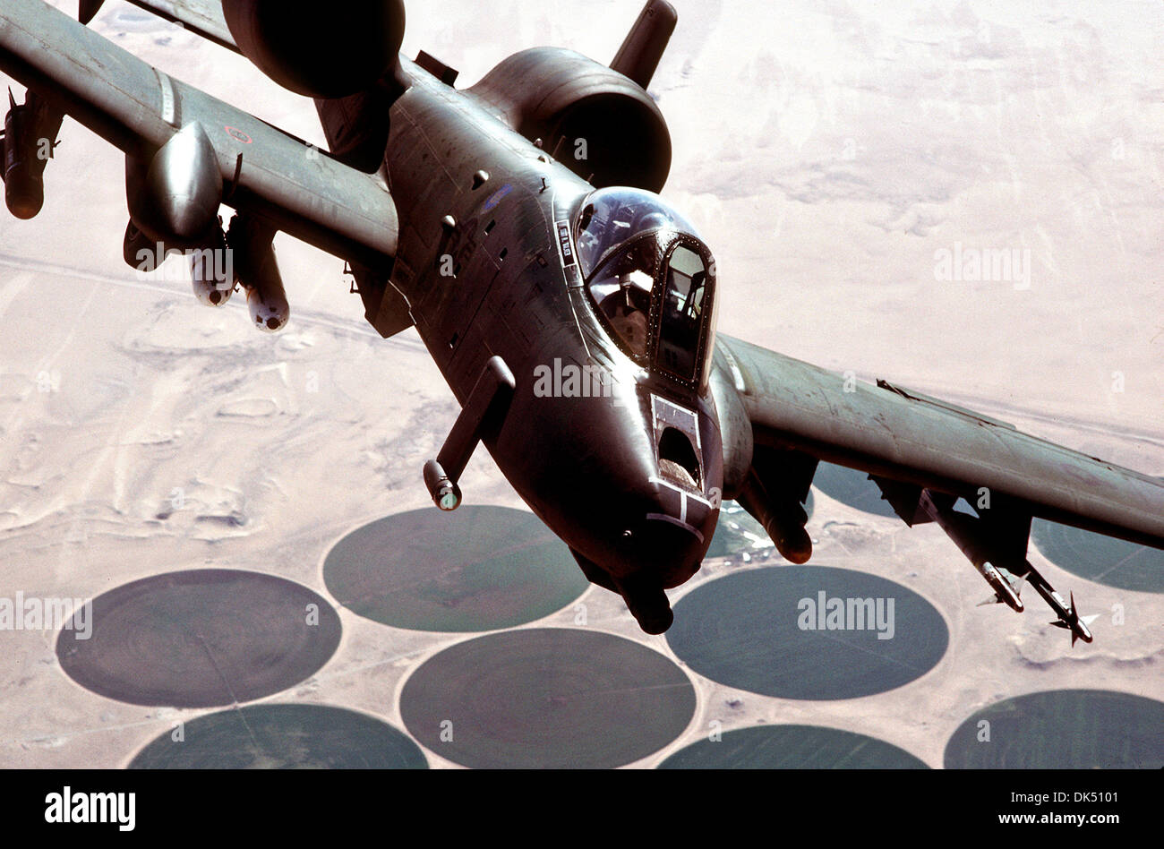 A US Air Force A-10A Thunderbolt II aircraft flies over a target area ...