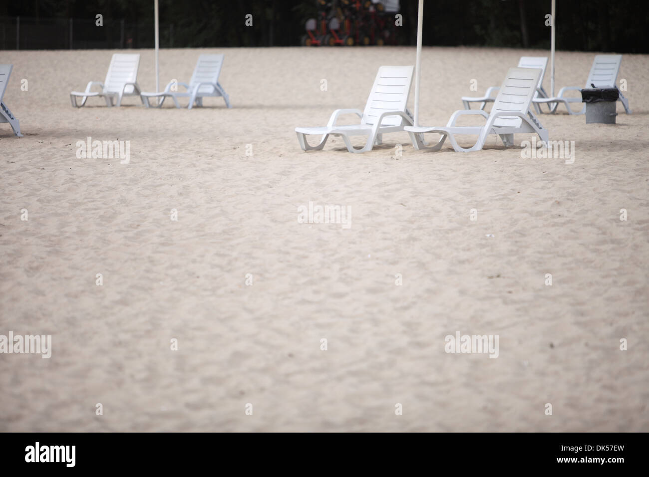 empty white pool plastic chairs deckchairs on sand beach. Vacation ...