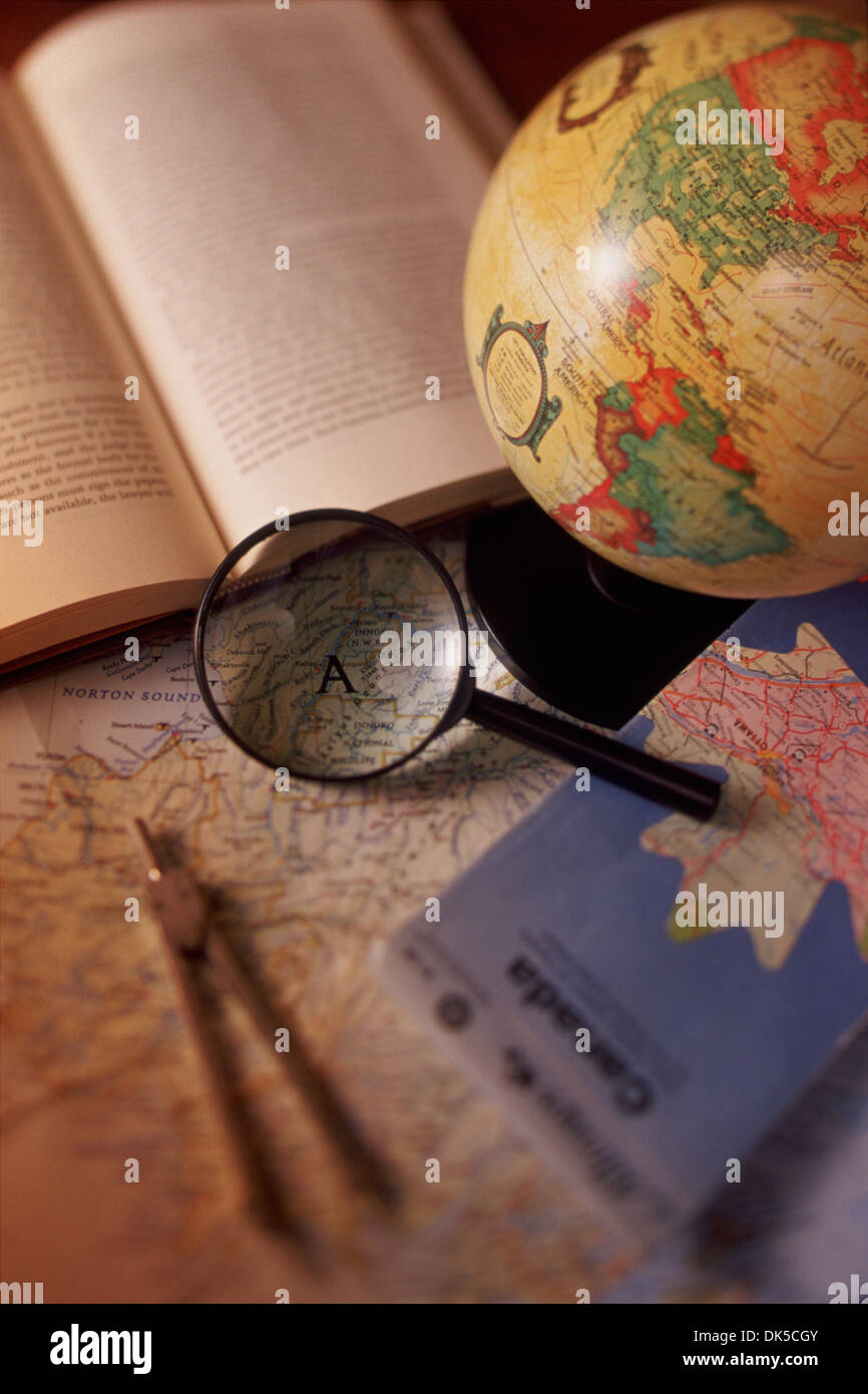 Magnifying glass, map and globe Stock Photo - Alamy