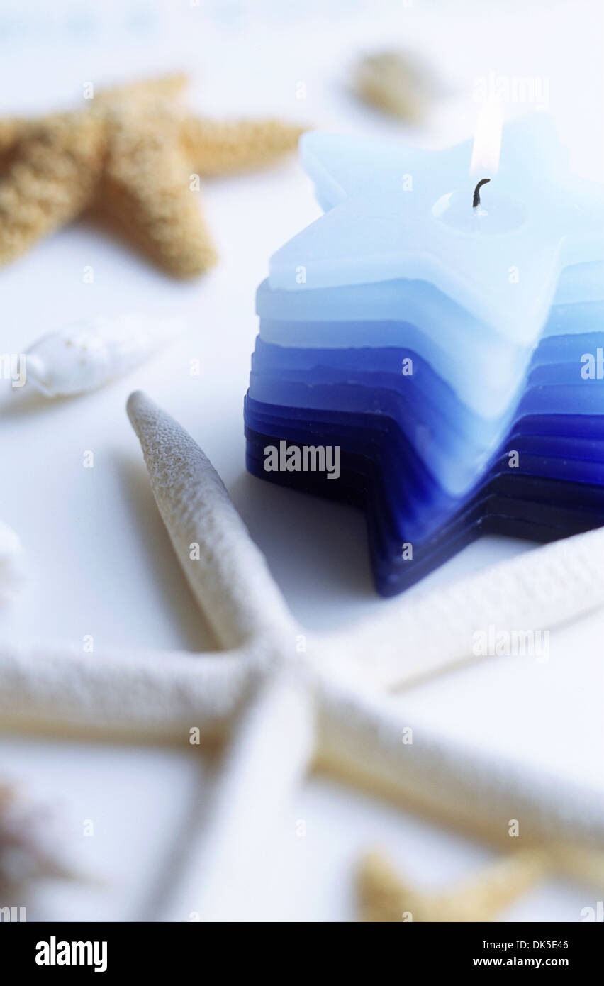 Starfish and star shaped candle Stock Photo - Alamy