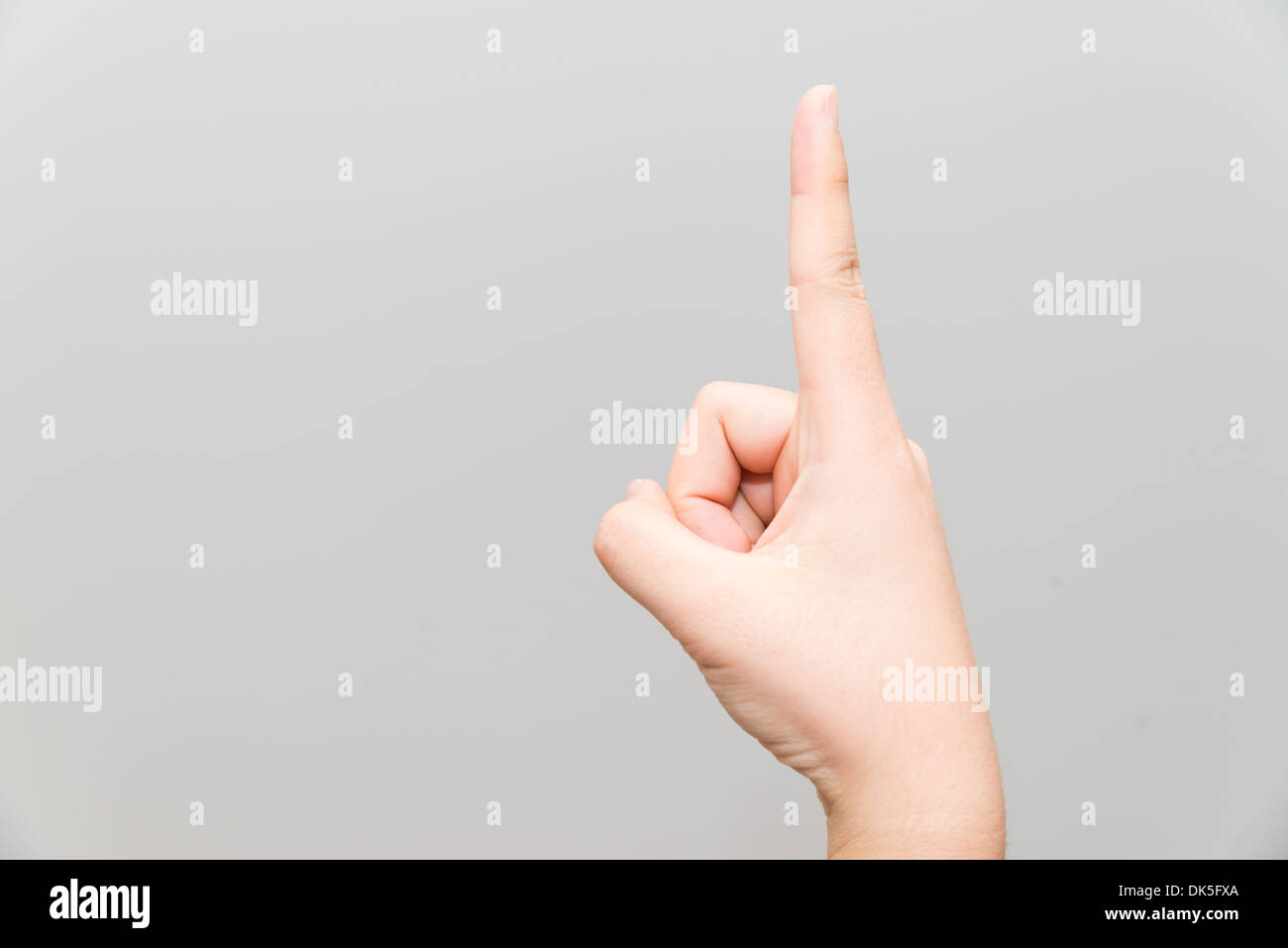 Human hand with one finger sticking up on light gray background Stock ...