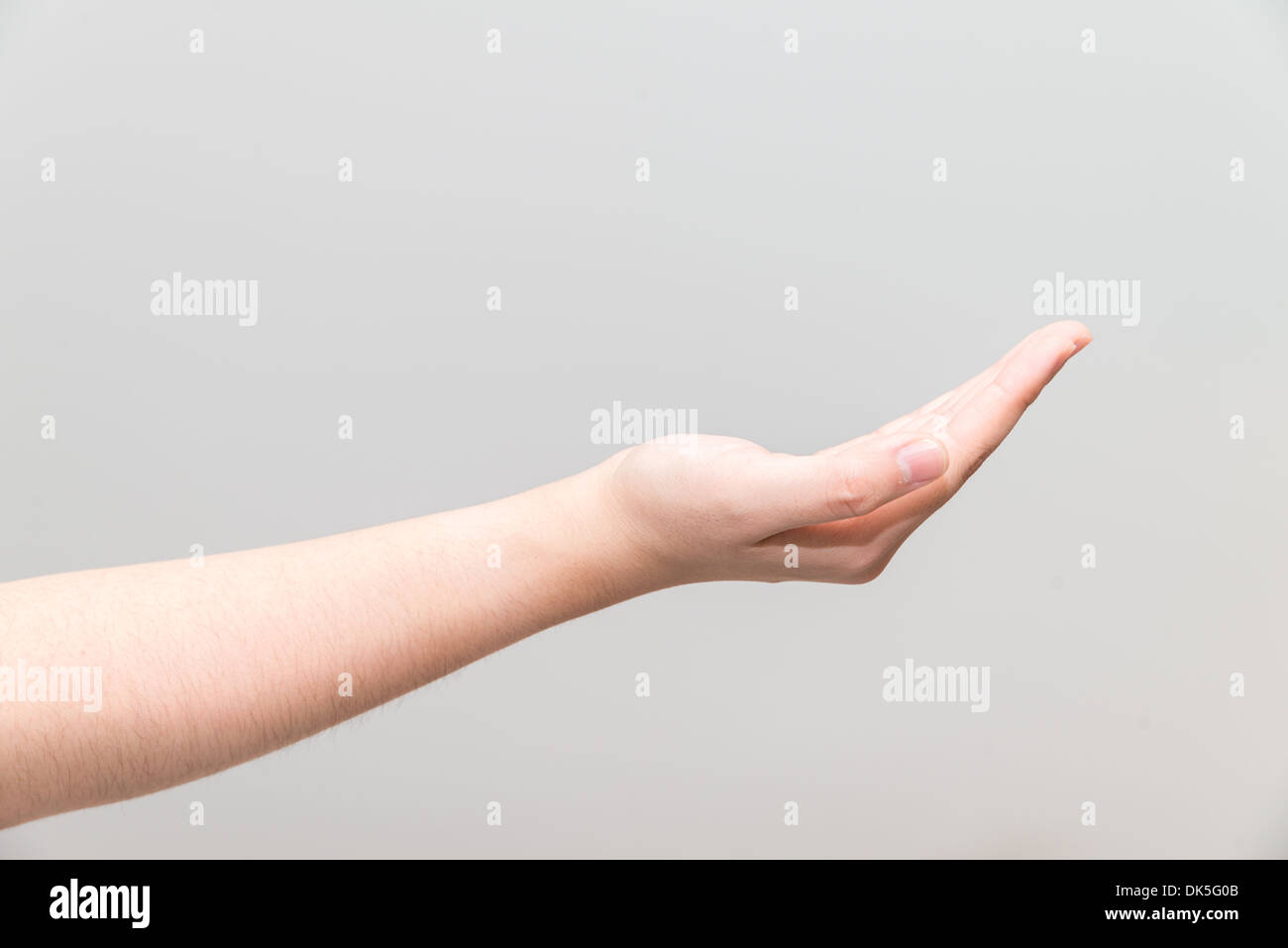 Human hand with open palm ready to recieve on light gray background ...
