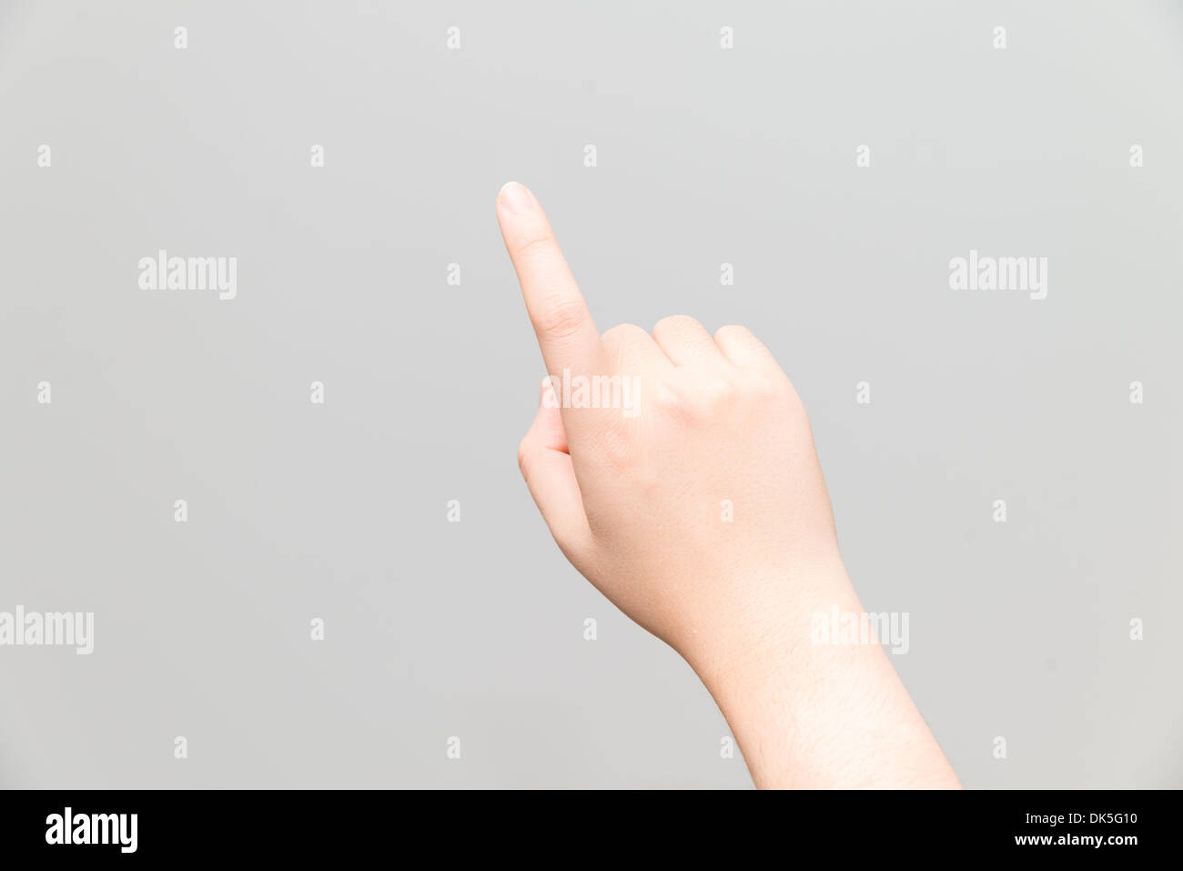 Human hand with one finger touching imaginary tablet on gray background ...