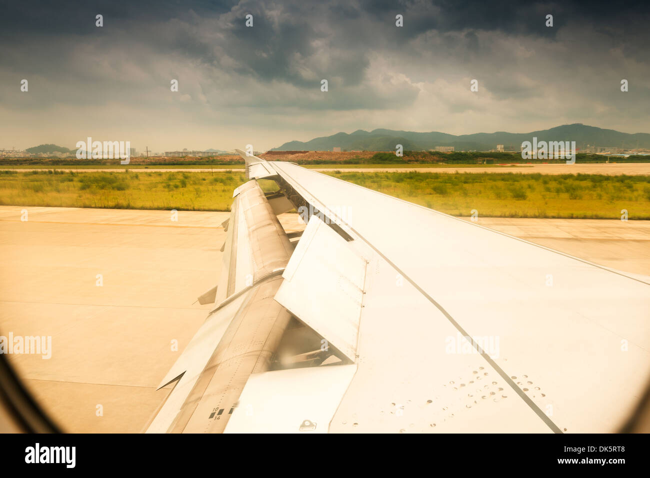 the wing is moving up when airplane is landing to runway Stock Photo ...