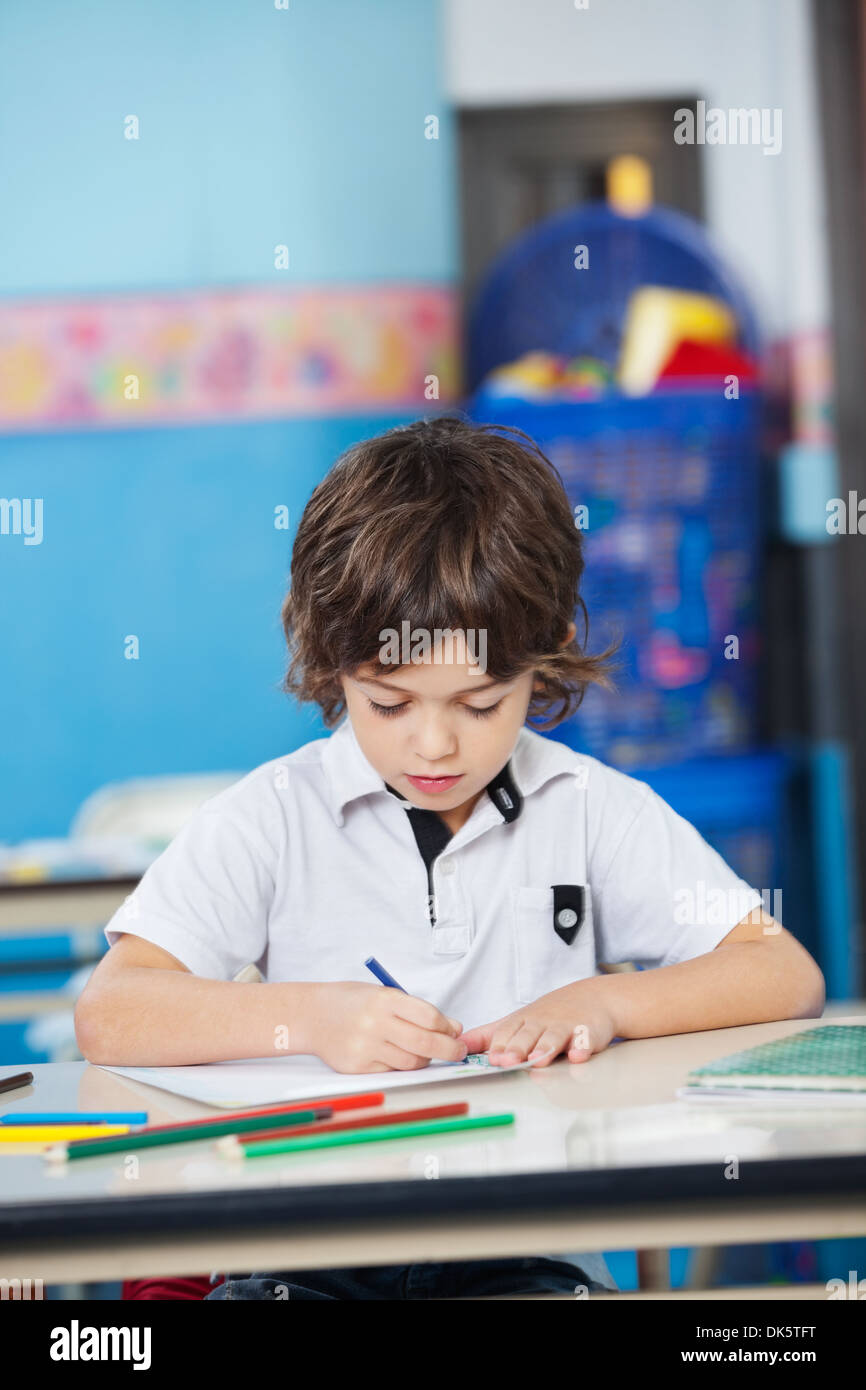 Boy With Sketch Pens Drawing In Kindergarten Stock Photo - Alamy