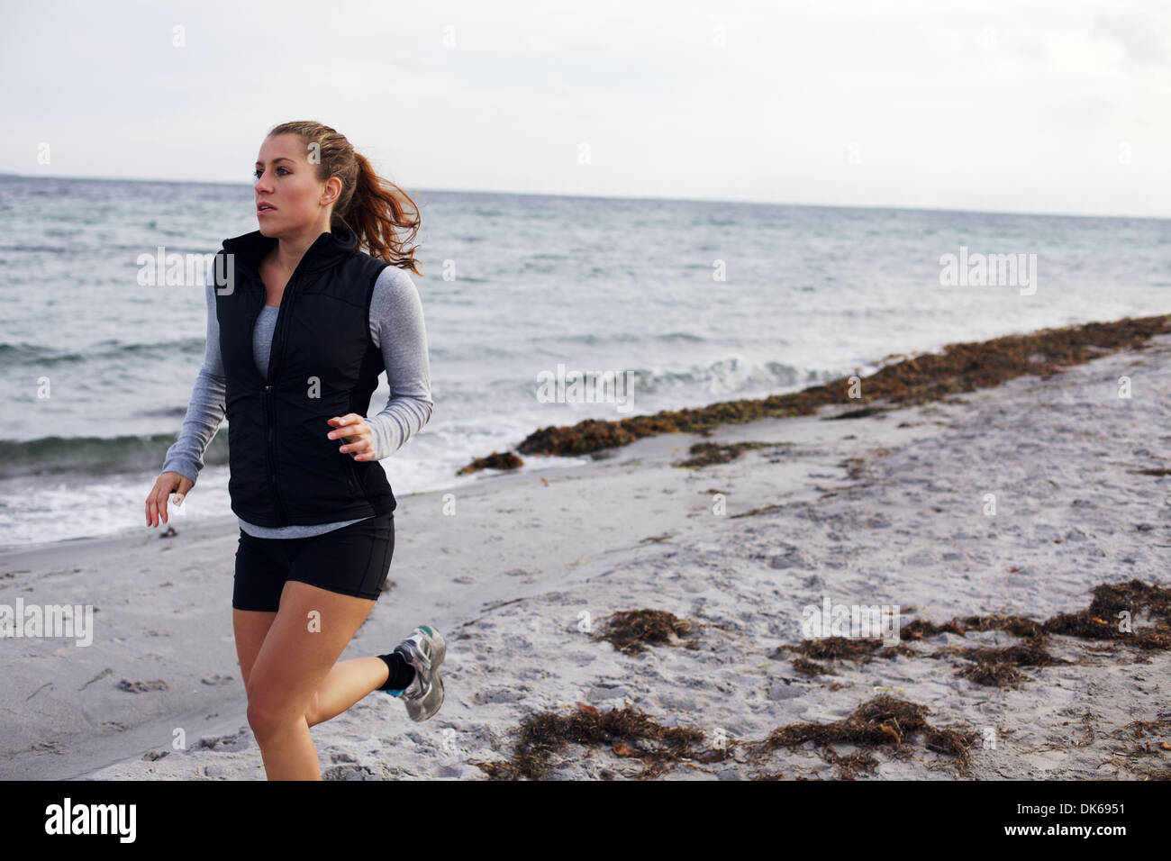 Female running on beach hi-res stock photography and images - Alamy