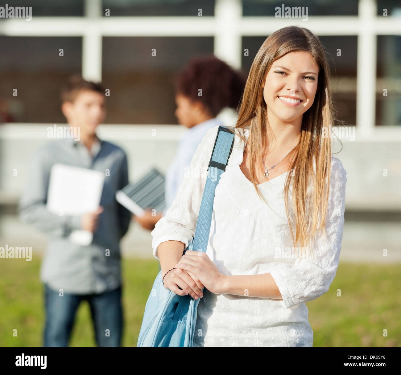 Happy Student Carrying Shoulder Bag Standing On College Campus Stock ...