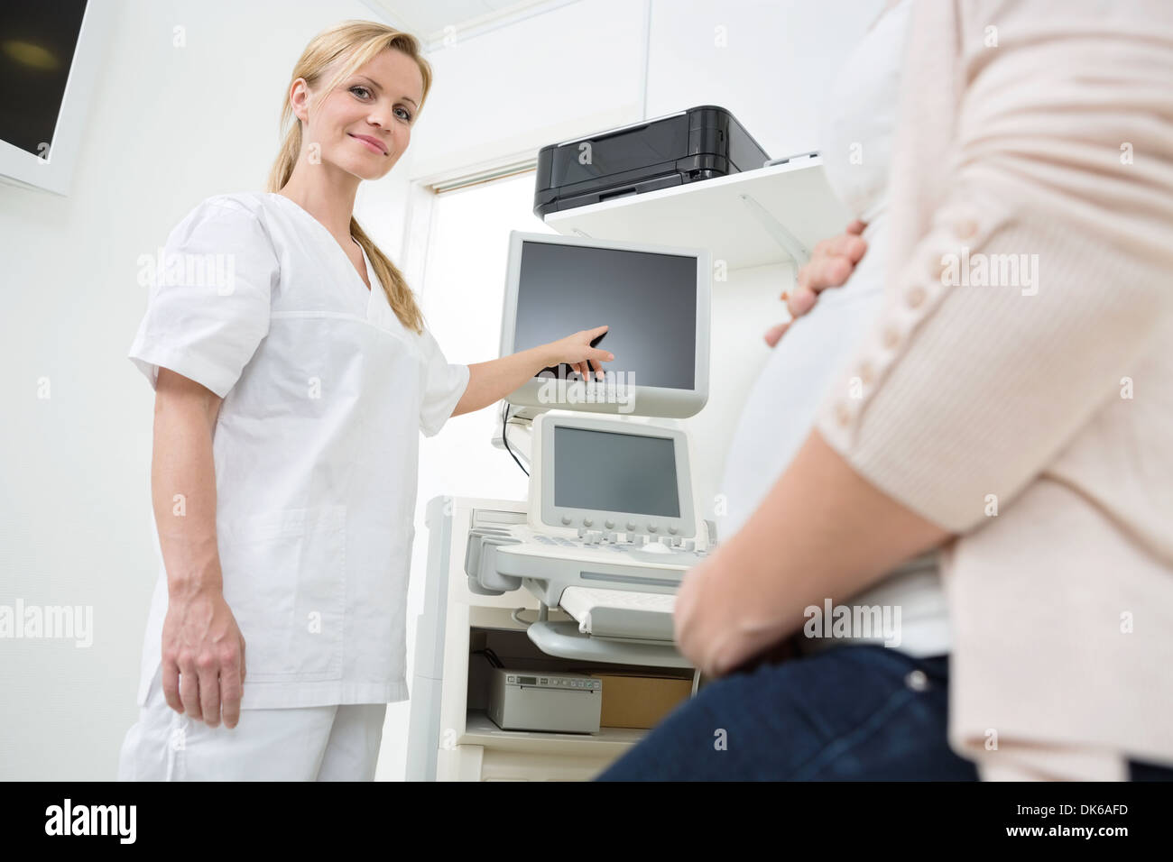 Gynecologist Showing Ultrasound Scan To Pregnant Woman Stock Photo - Alamy