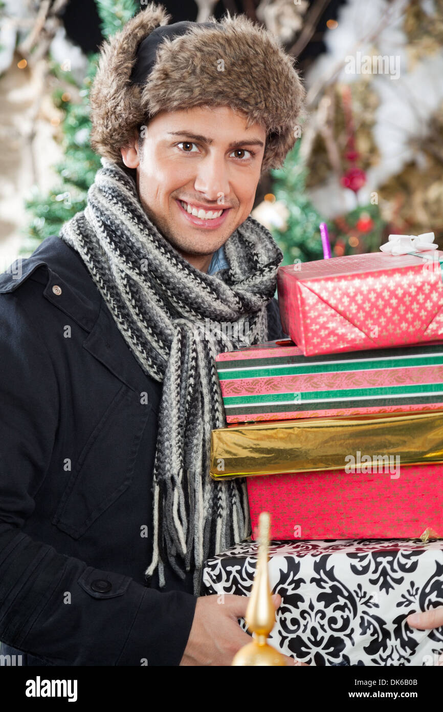 Happy Man Carrying Stacked Gift Boxes Stock Photo - Alamy