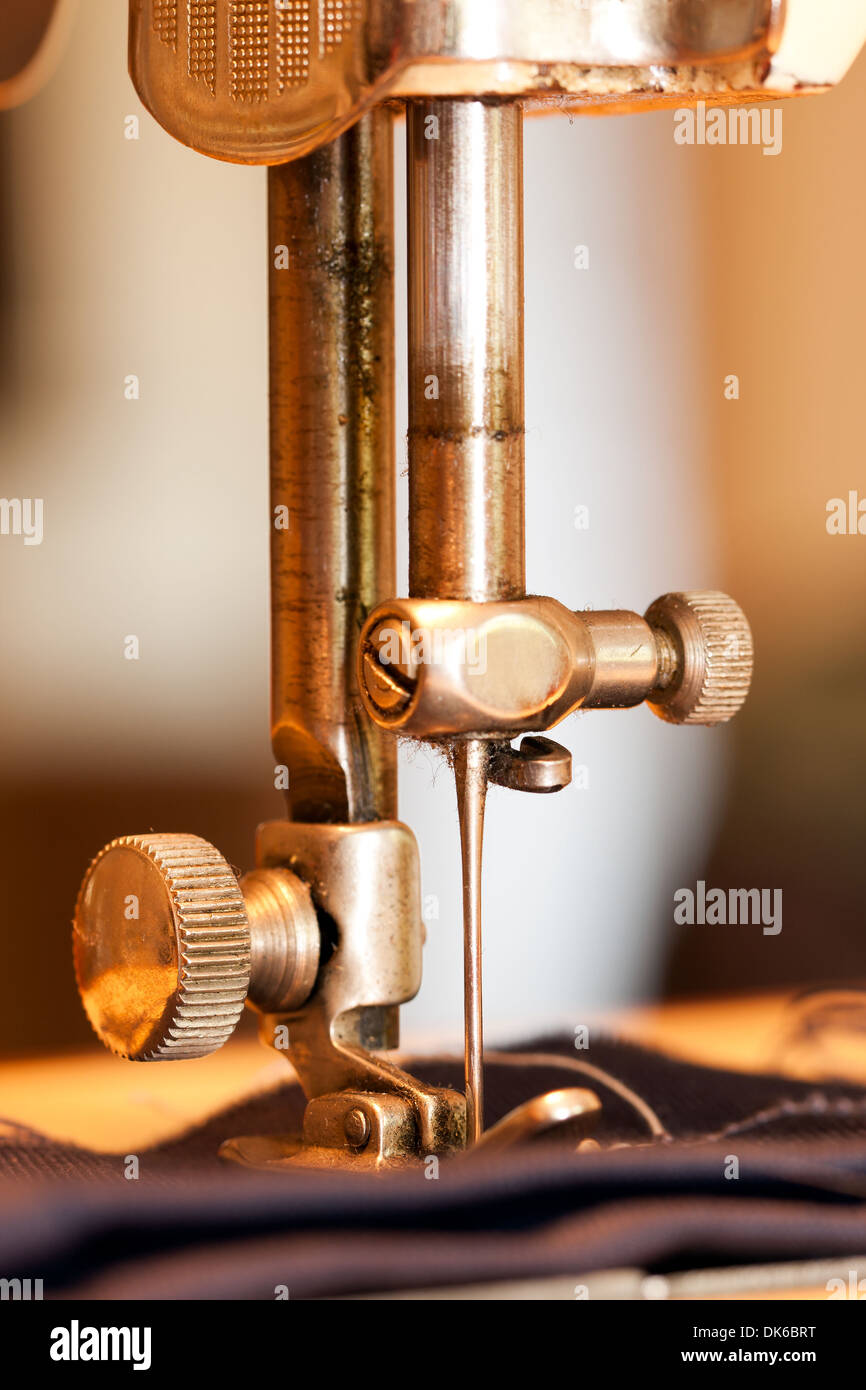 Closeup of a needle of a sewing machine that is sewing a textile or ...