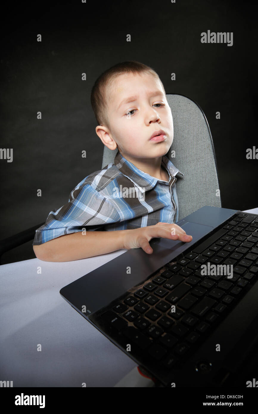 Computer addiction child boy with laptop notebook black background ...