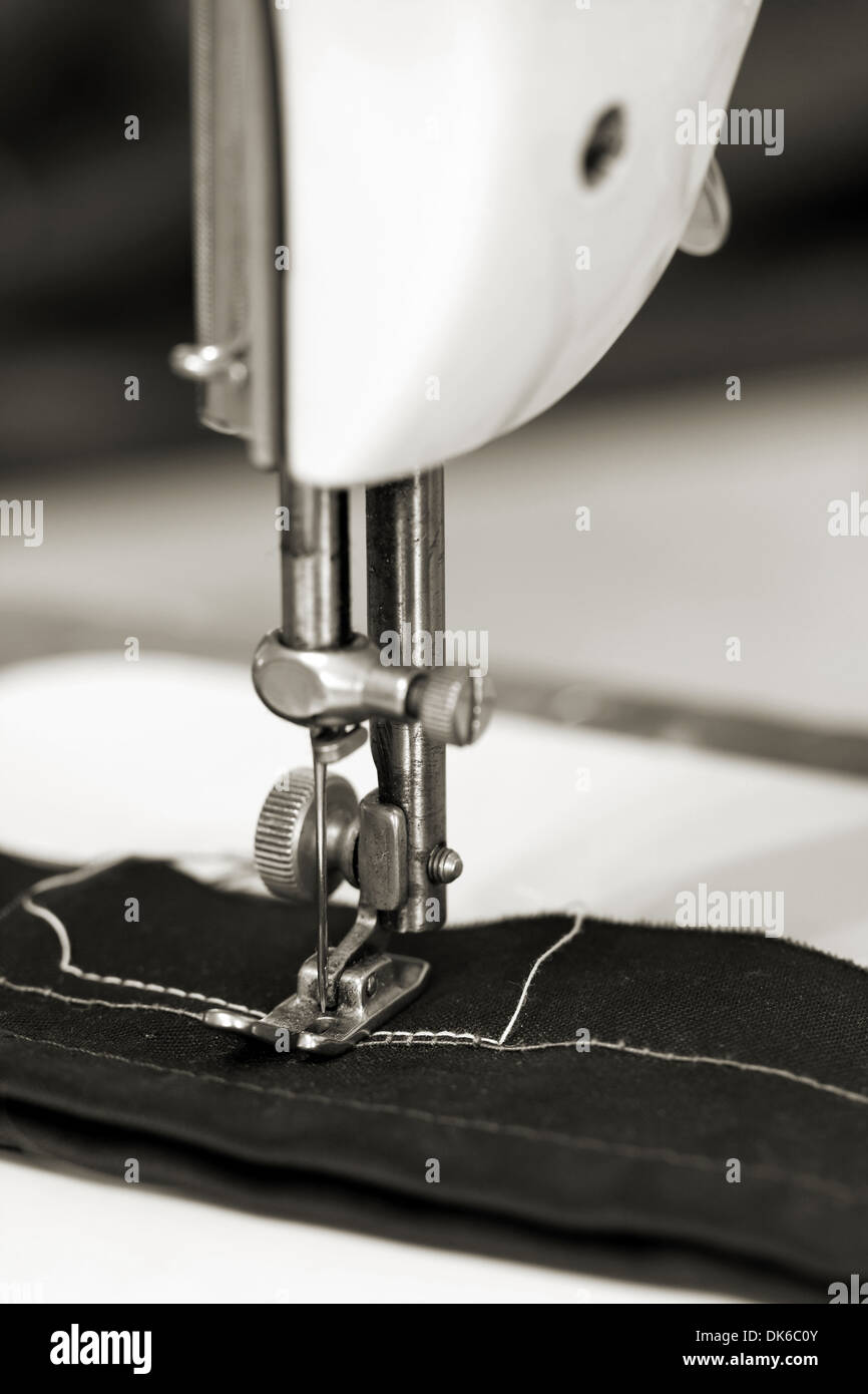 Closeup of a needle of a sewing machine that is sewing a textile or ...
