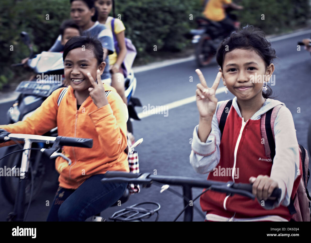 children make hand signs on bikes Stock Photo - Alamy