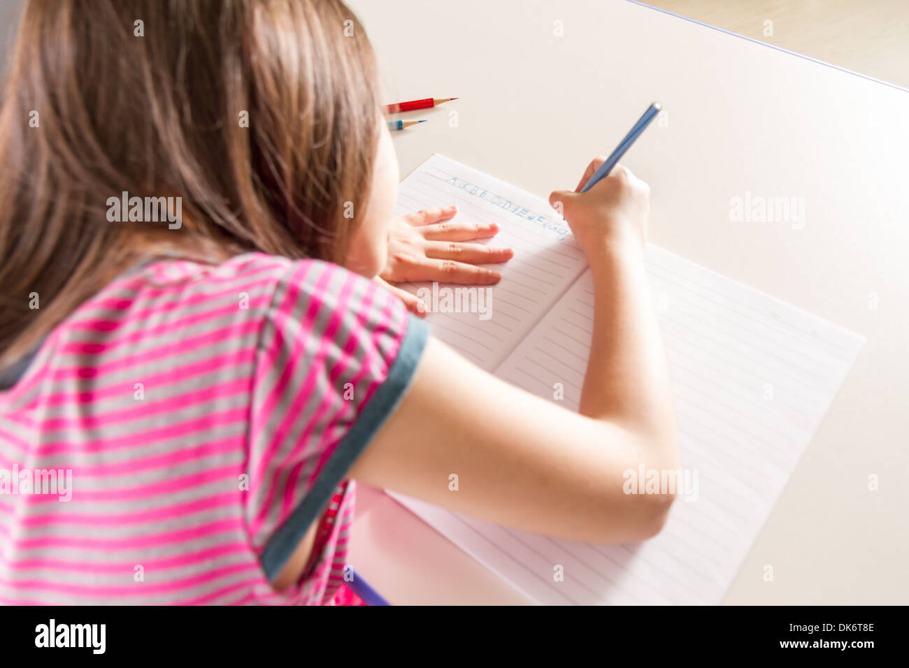 Girl doing school work in classroom hi-res stock photography and images ...
