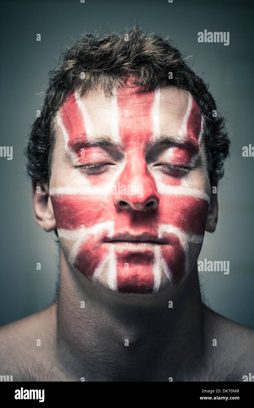 Portrait of man with British flag painted on his face and closed eyes ...