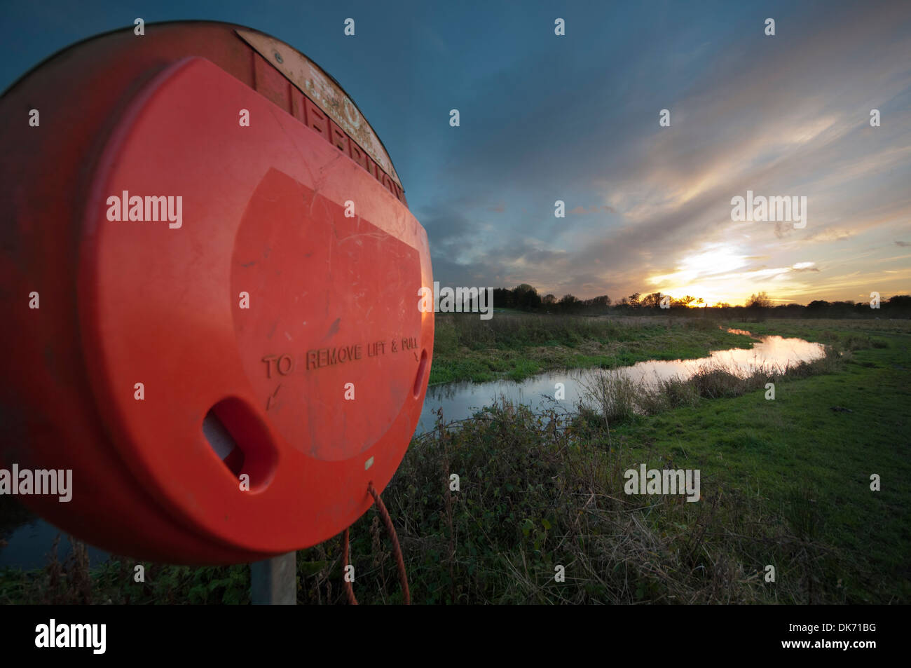 Red Life ring on river bank Stock Photo - Alamy