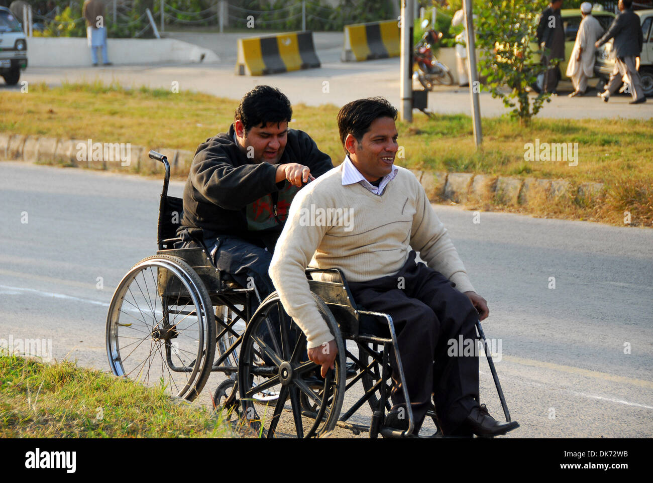 Islamabad, Pakistan. 3rd Dec 2013. Disabled people enjoy at a public ...