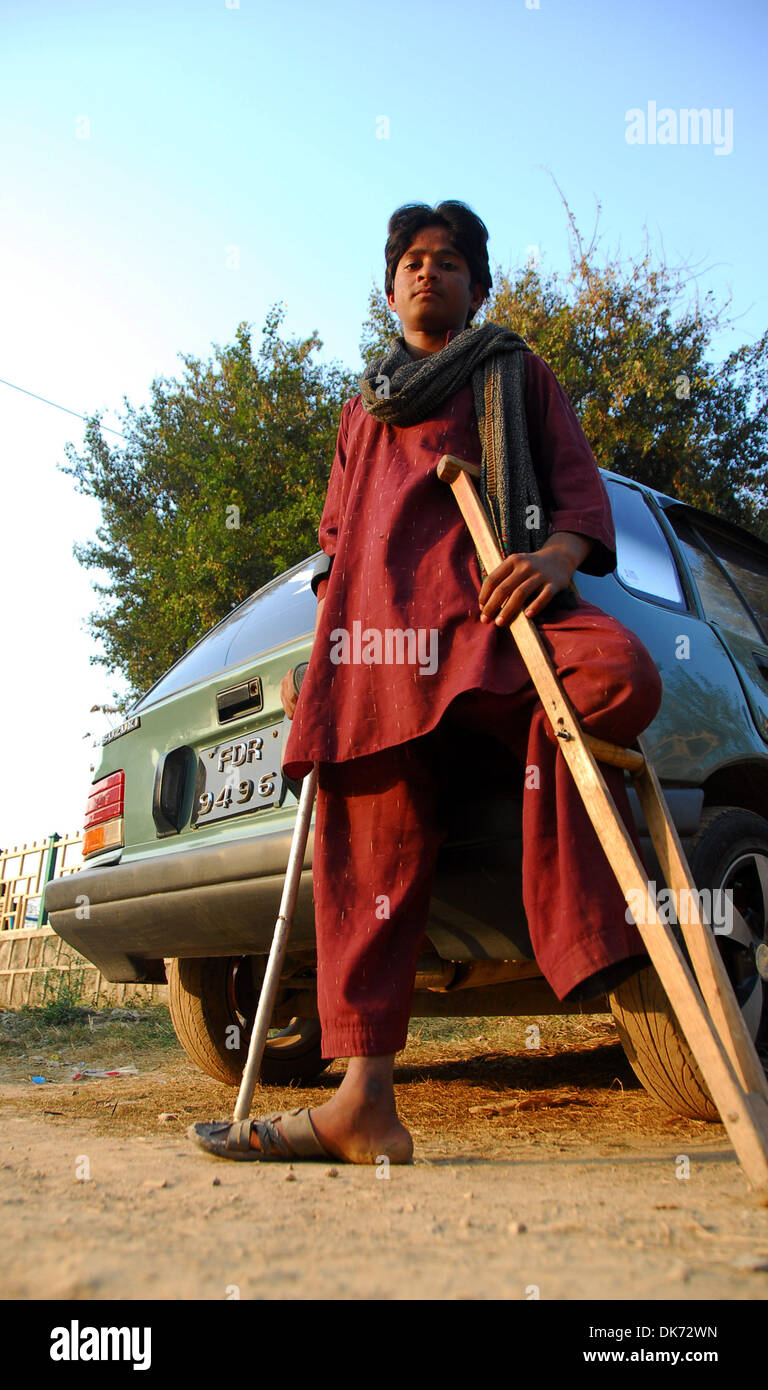 Islamabad, Pakistan. 3rd Dec 2013. A disabled boy poses for a photo at ...