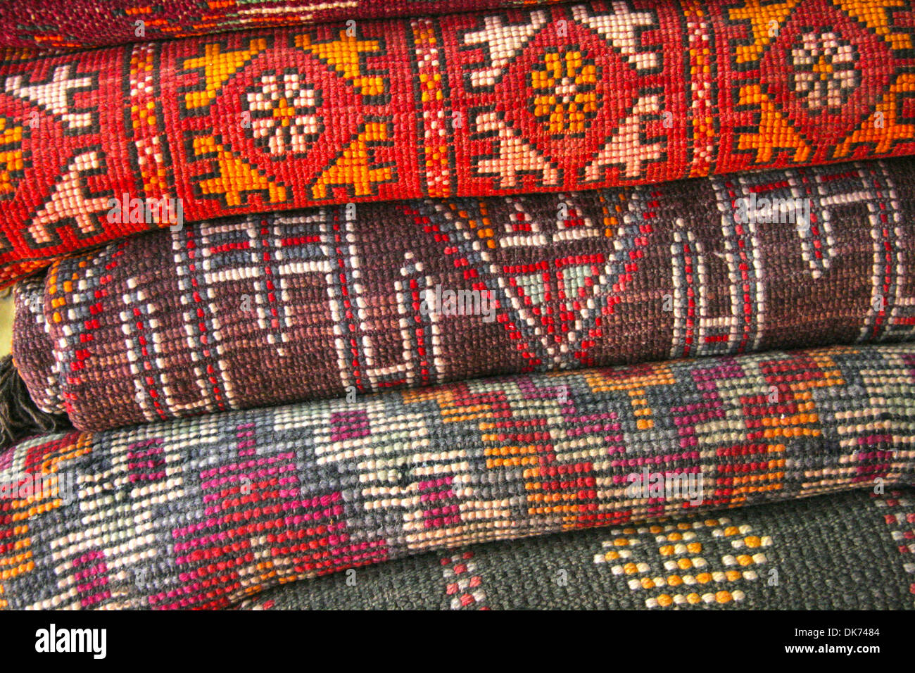 Pile of north african rugs in red, orange & brown shades, Morocco Stock ...