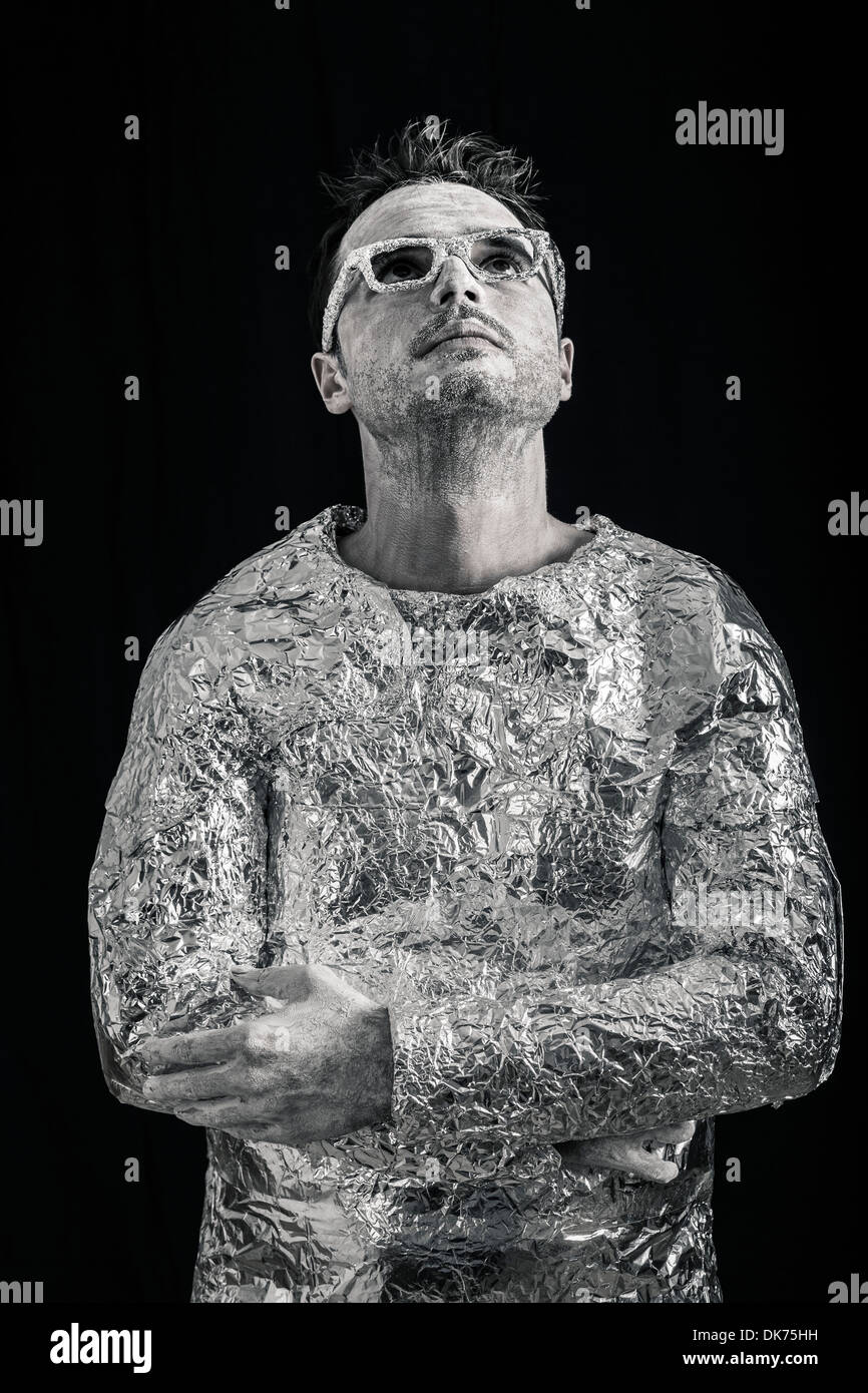 Portrait of alien man looking up, over dark background Stock Photo - Alamy