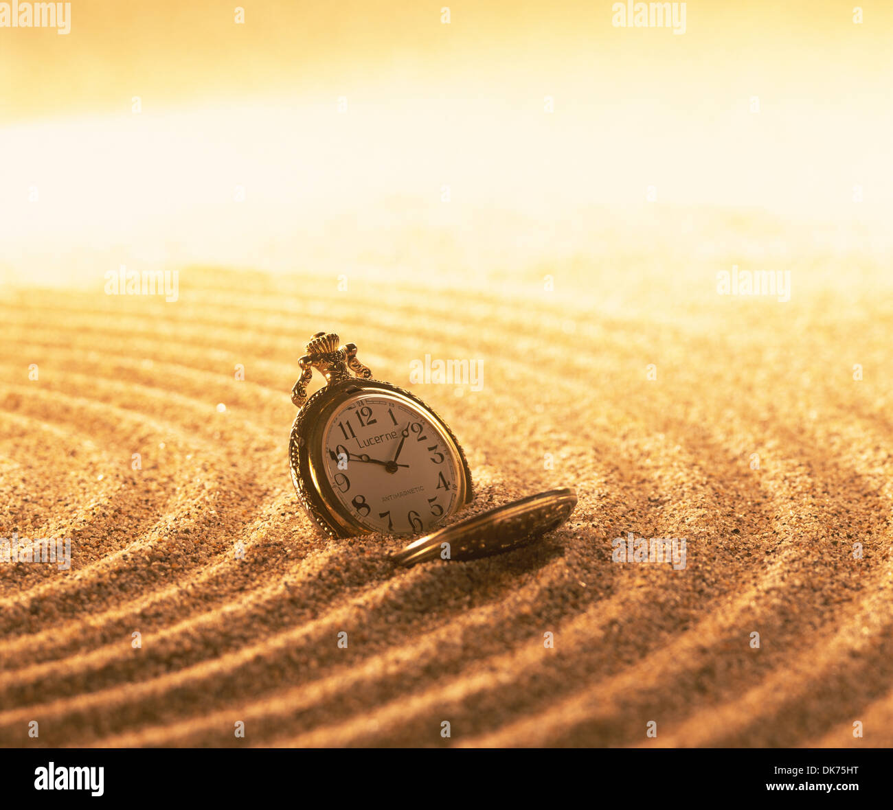 Clock on sand Stock Photo - Alamy