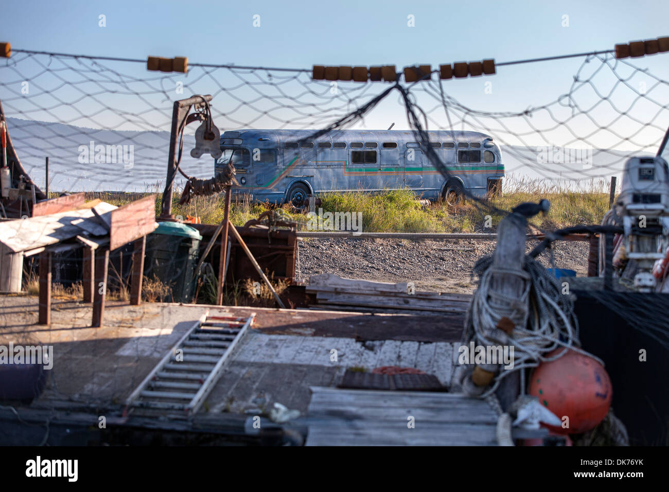 A bus and a fishing net at a junkyard on The Spit in Homer, Alaska, USA ...