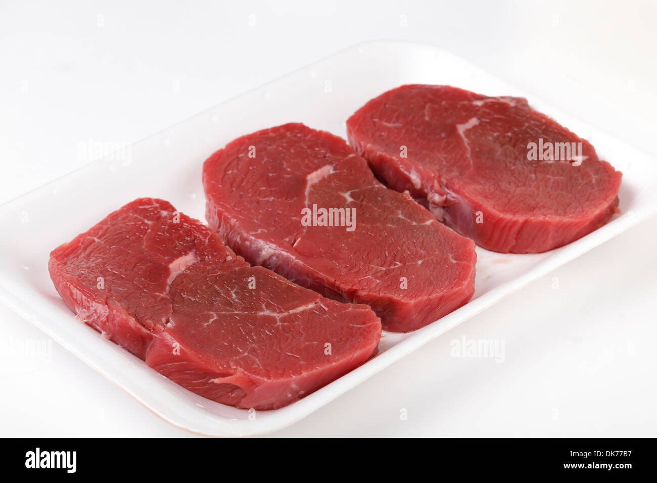 Three raw minute steaks displayed in a butcher's polystyrene tray Stock ...