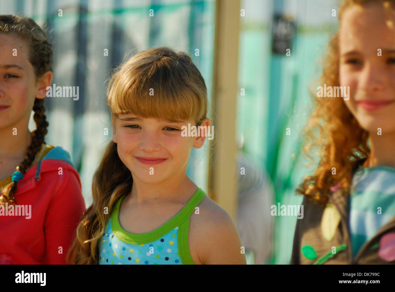 Three girls standing shoulder to shoulder Stock Photo - Alamy