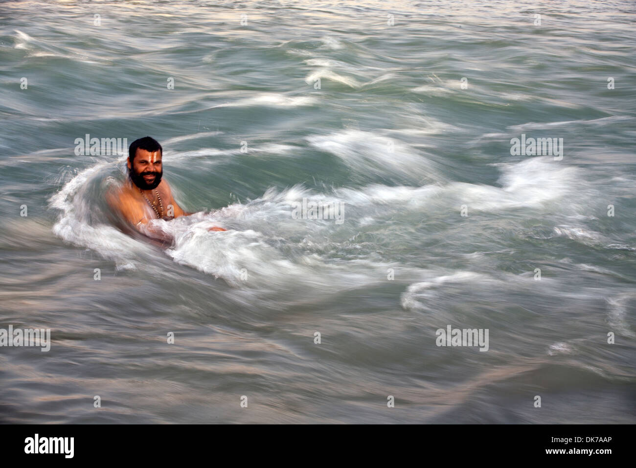 Indian Hindu man having a bath in the Ganges river Ganges Haridwar ...