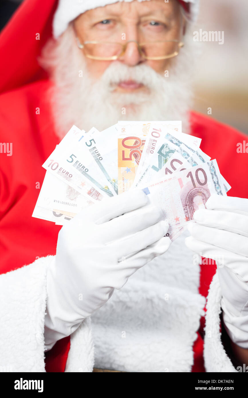 Santa Claus Holding Money Stock Photo - Alamy