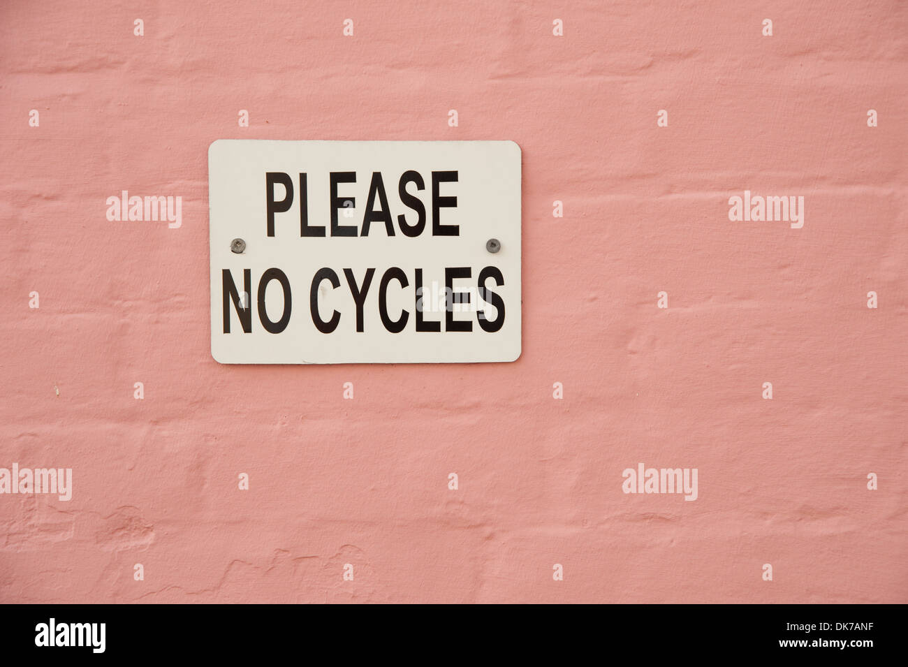 Please No Cycles sign on a pink painted wall Stock Photo - Alamy