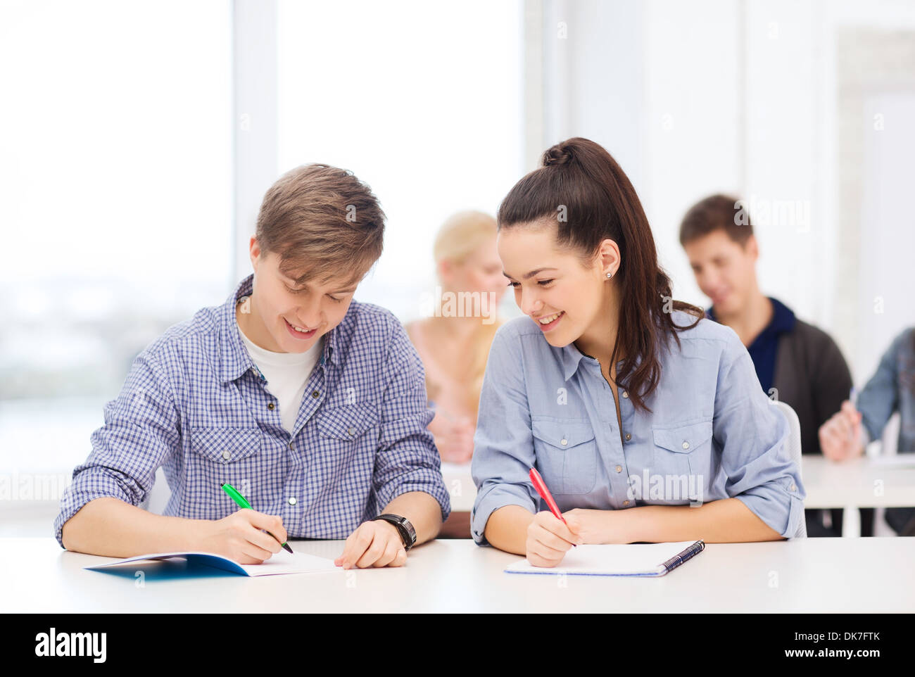 two teenagers with notebooks at school Stock Photo - Alamy
