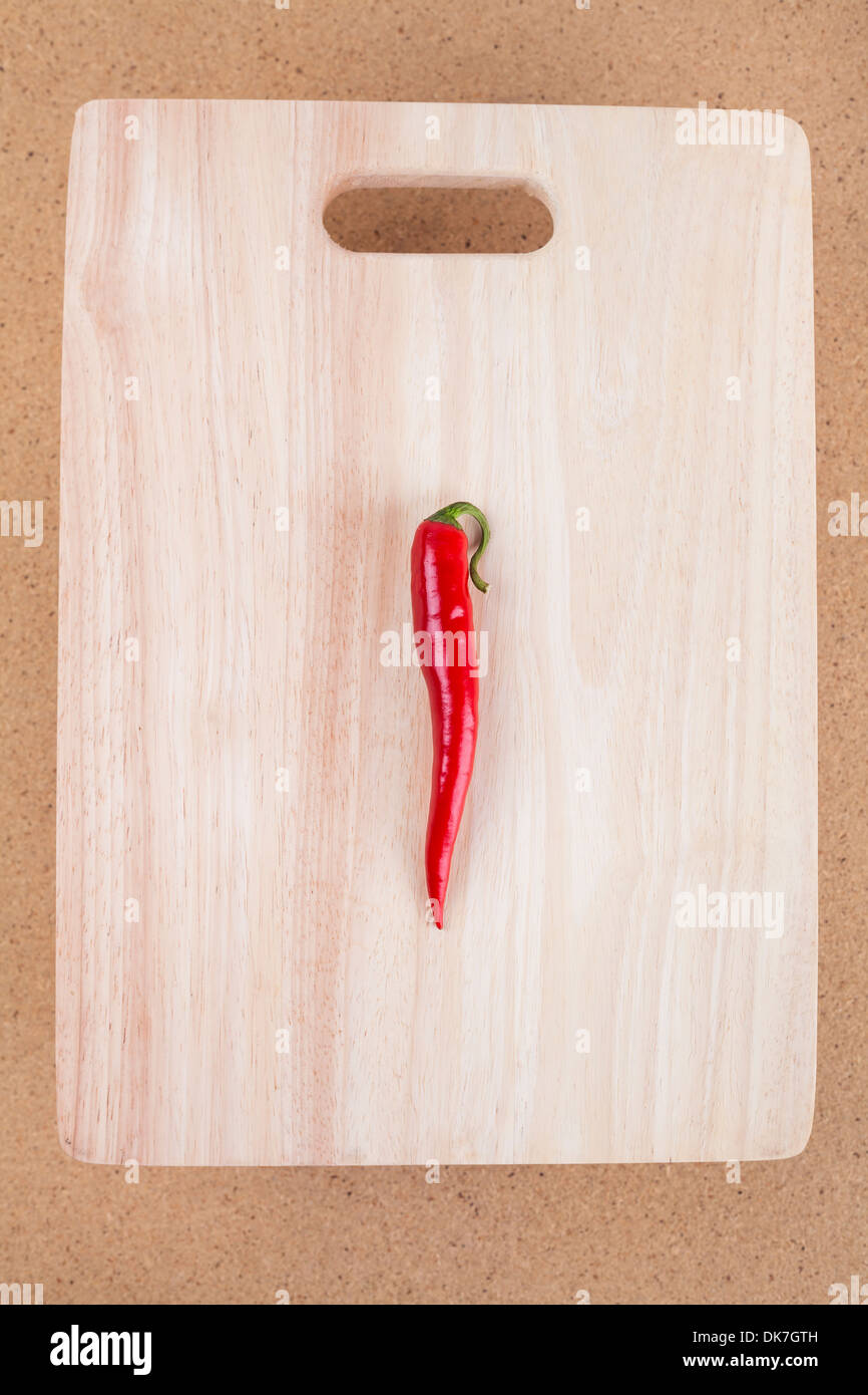 Fresh raw red hot chili pepper on chopping board Stock Photo - Alamy